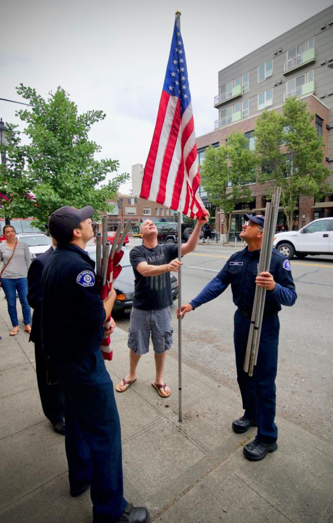 Flags go up in the West Seattle Junction for Memorial Day